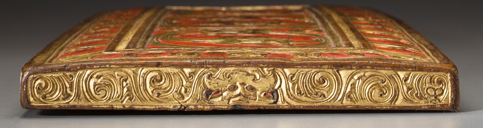 Bonhams : A gilt polychromed wood manuscript cover Tibet, 13th century
