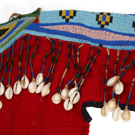 Bonhams Skinner : A Plains beaded cloth dress lg. 36, wd. 30 1/4 in.