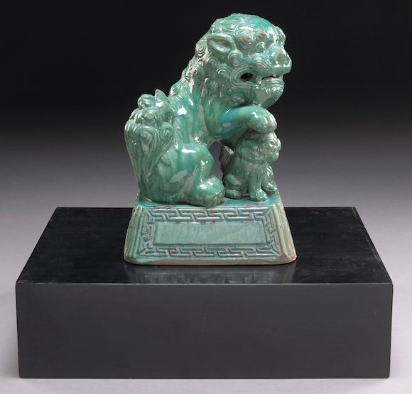 Bonhams : A Chinese style glazed earthenware model of a Foo dog, raised ...