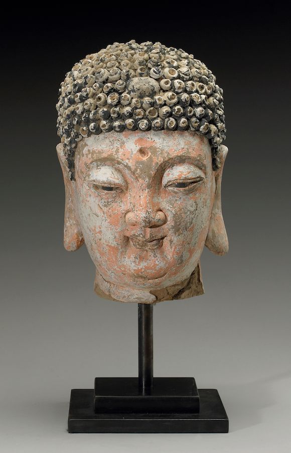 Bonhams : A polychromed stucco head of Buddha Ming Dynasty