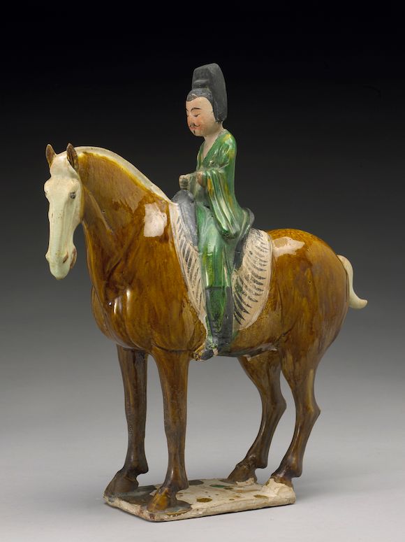 Bonhams : A sancai glazed model of a horse and rider Tang Dynasty