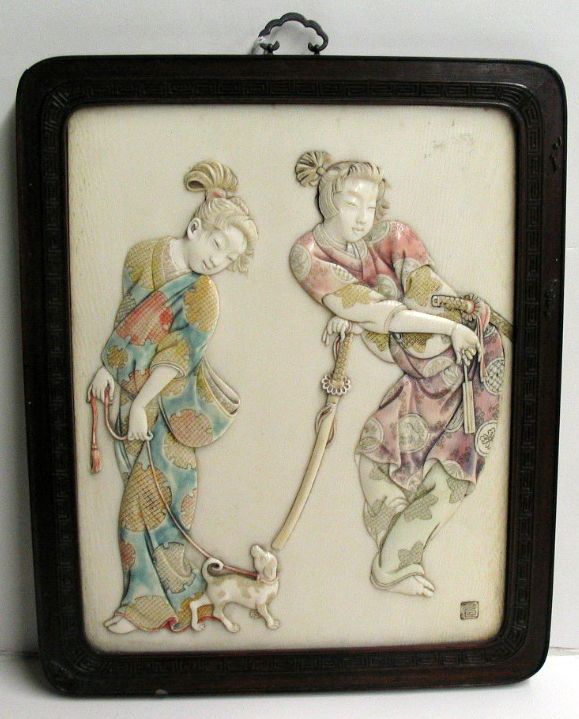 Bonhams : A carved ivory panel of a young samurai and a beauty Meiji Period