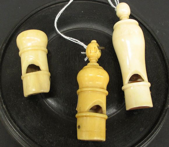 Bonhams : A group of three bone whistles