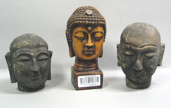 Bonhams : Two Asian stone heads and one composition head