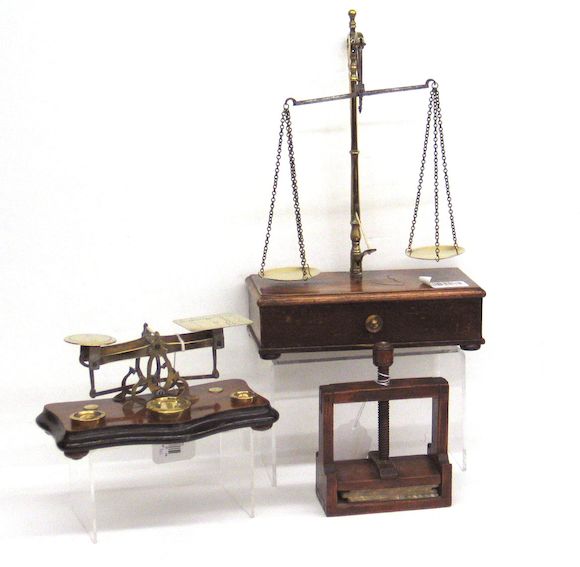 Bonhams : Two small brass scales and a small book press