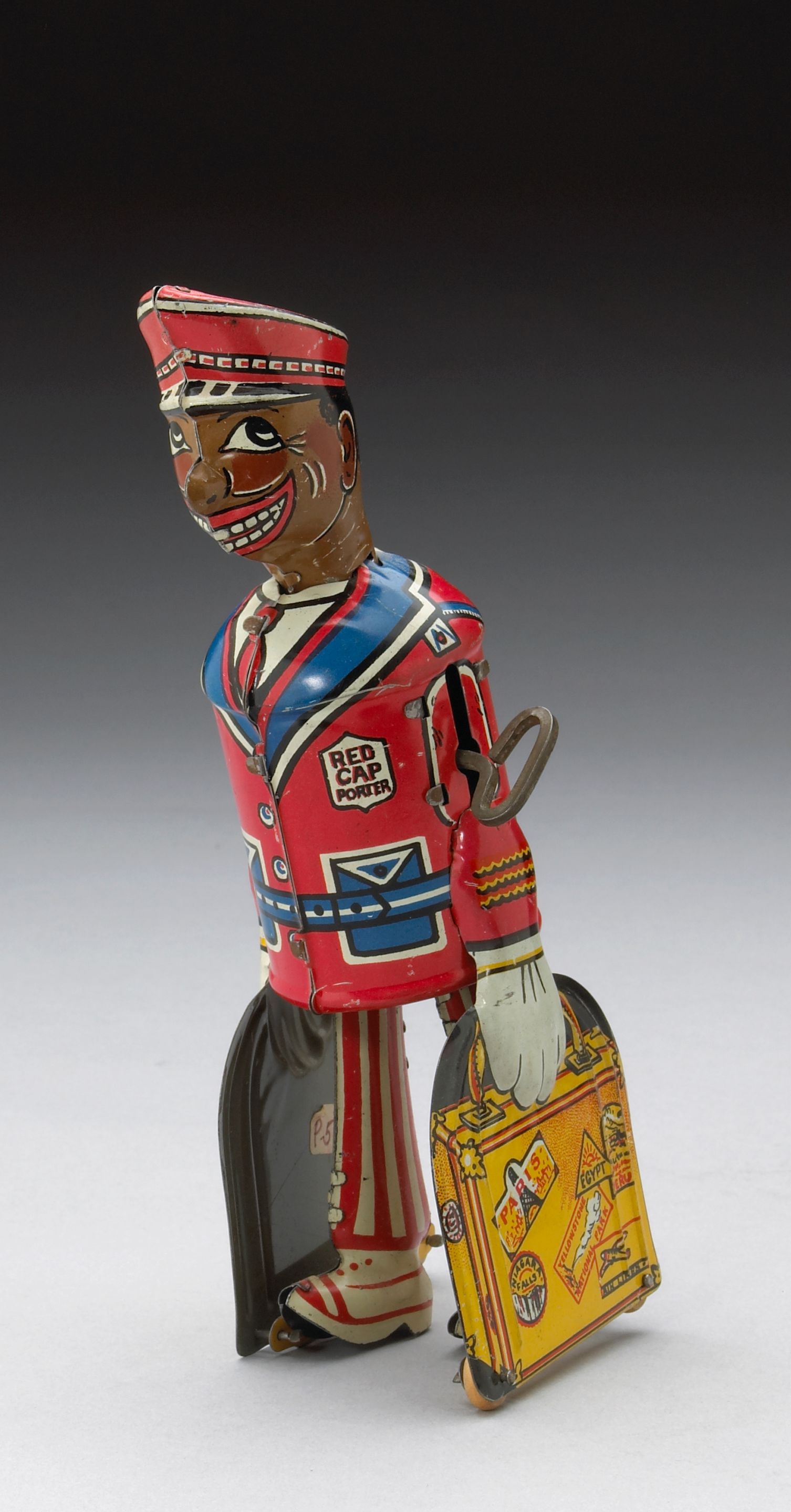 Bonhams Cars : A Red Cap Porter tin wind-up toy Height: 8in