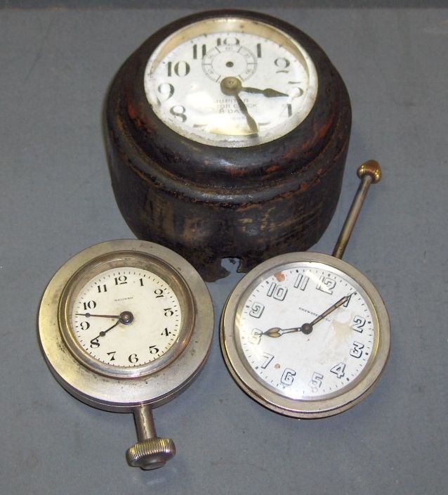 Bonhams Cars : A grouping of three white dialed car clocks,
