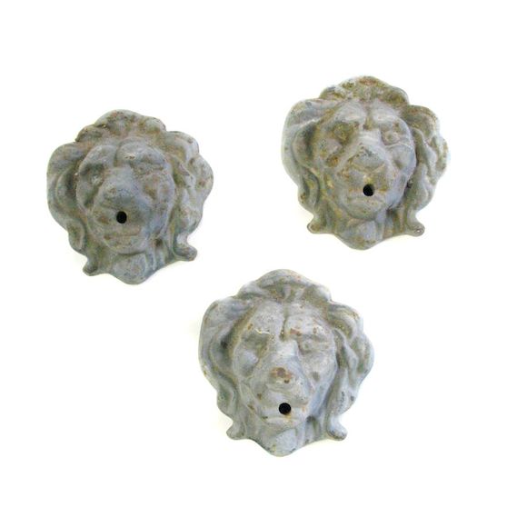 Bonhams : A set of three cast iron lion masks
