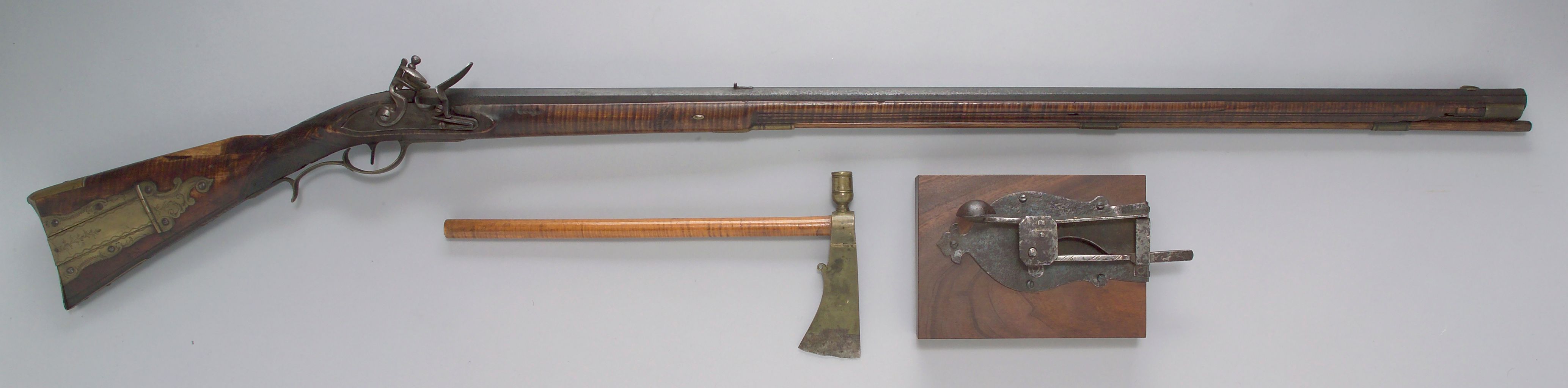 An American full-stocked flintlock rifle and pipe tomahawk by Jacob ...