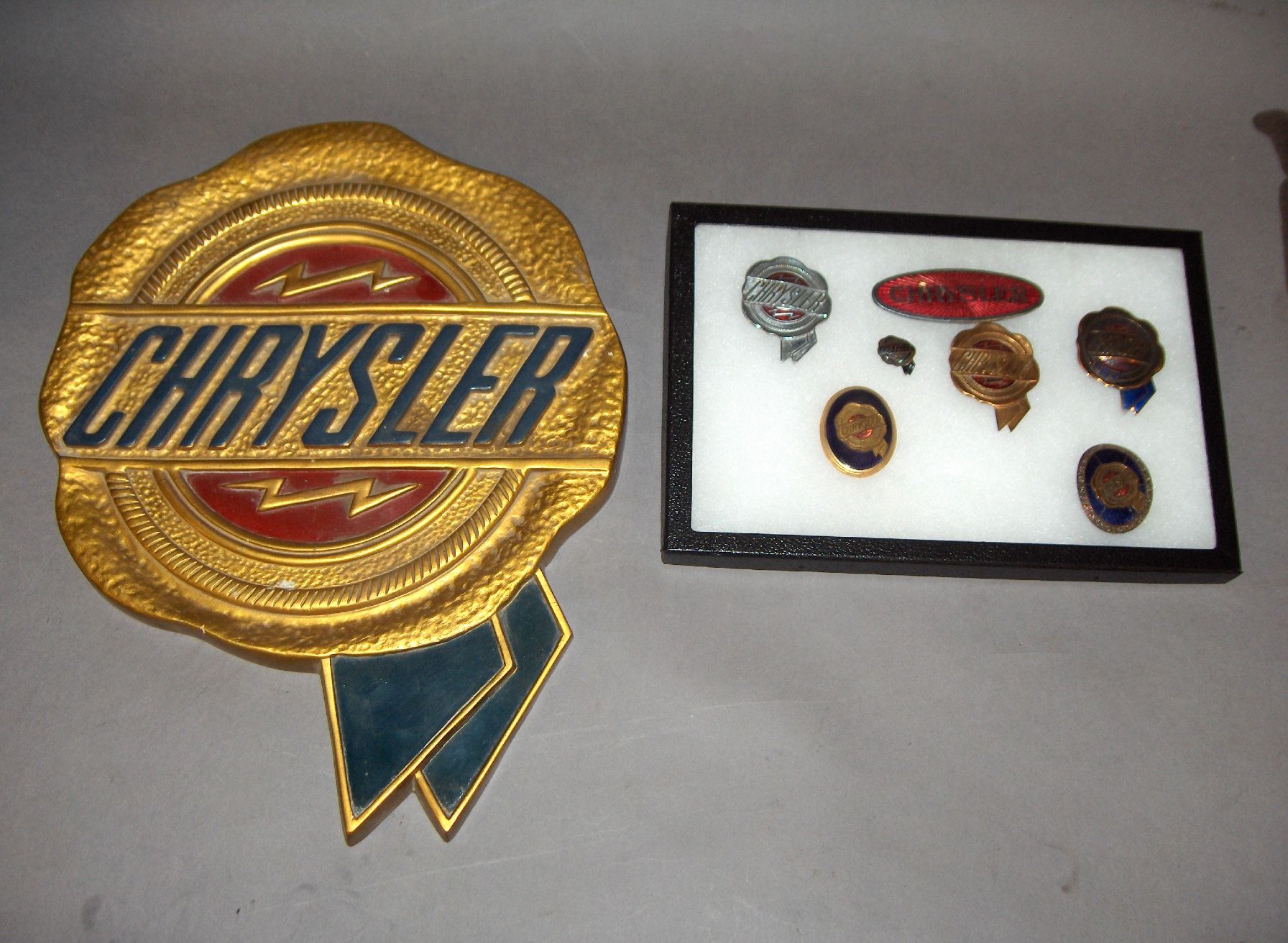 Bonhams Cars : An assortment of Chrysler badges and emblems,