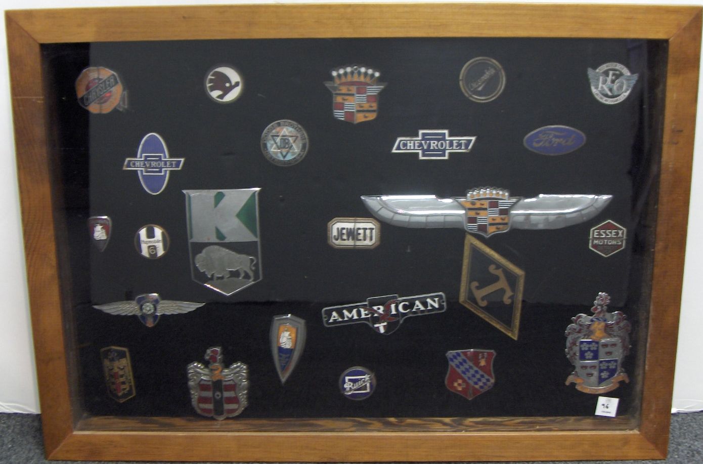 Bonhams Cars : A framed display of twenty-four badges, the case 22 x 31in