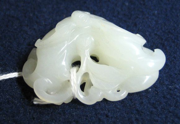 Bonhams : A small white nephrite study of a bat and water caltrops