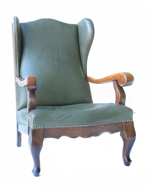 Bonhams : A green leather upholstered wing back library chair