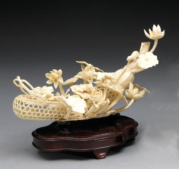 Bonhams : A carved ivory study of a crab basket and lotus plant