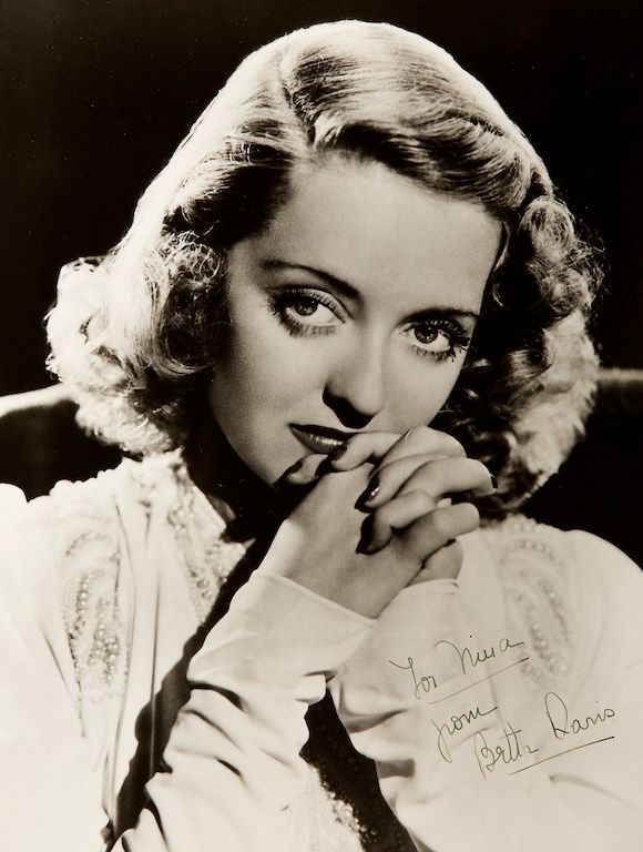 Bonhams : A Bette Davis signed black and white photograph, 1940s