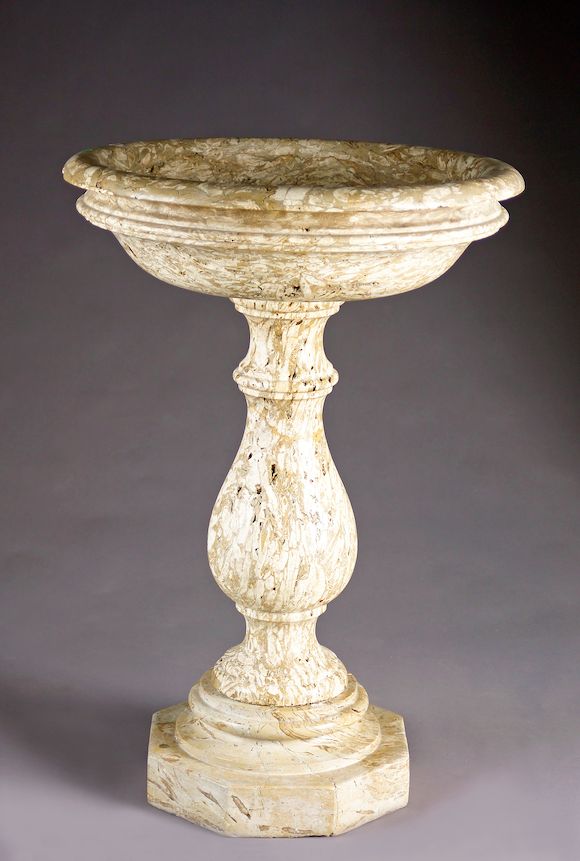 Bonhams : An Italian Neoclassical travertine marble bird bath