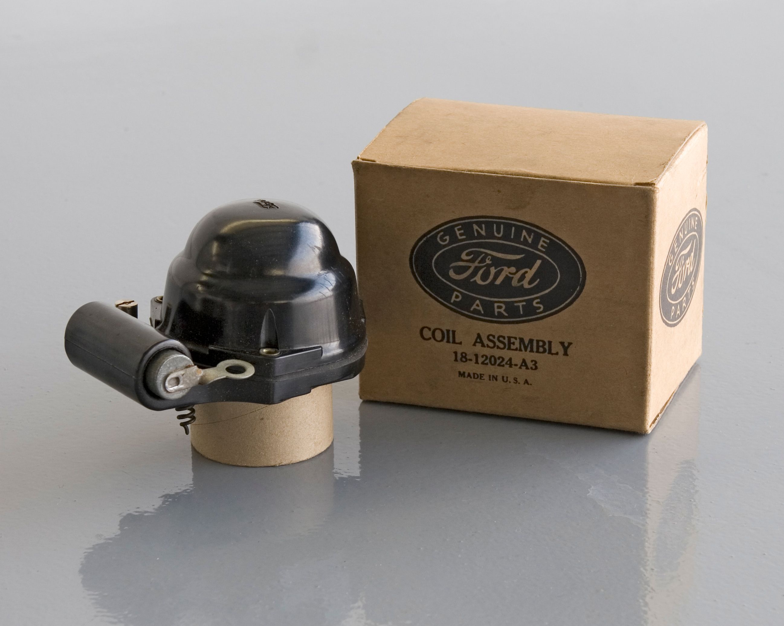Bonhams Cars : A 1933-1934 Ford NOS ignition coil in the box.