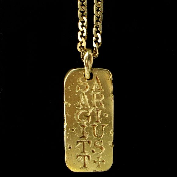 Bonhams : A gold Sagittarius pendant with 18k gold chain,