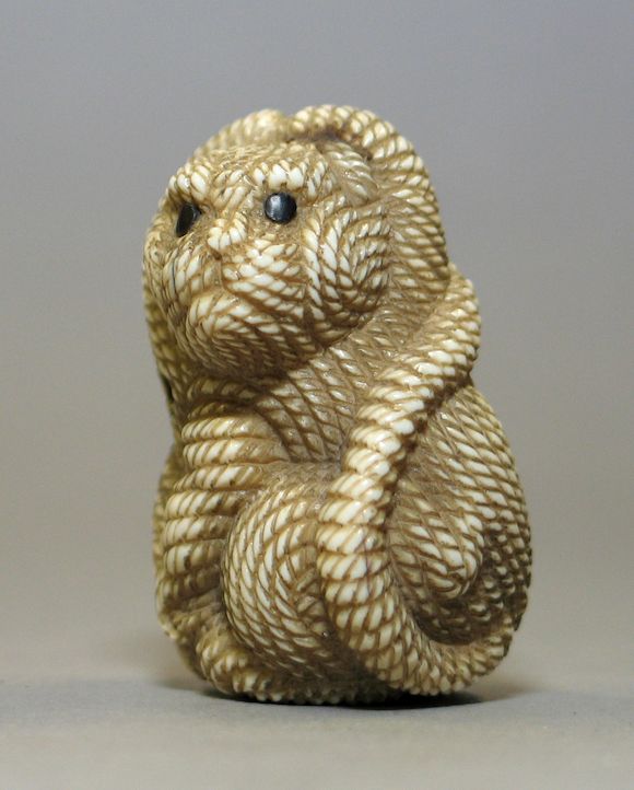 Bonhams : A tinted ivory netsuke of a tiger and a black and gilt ...