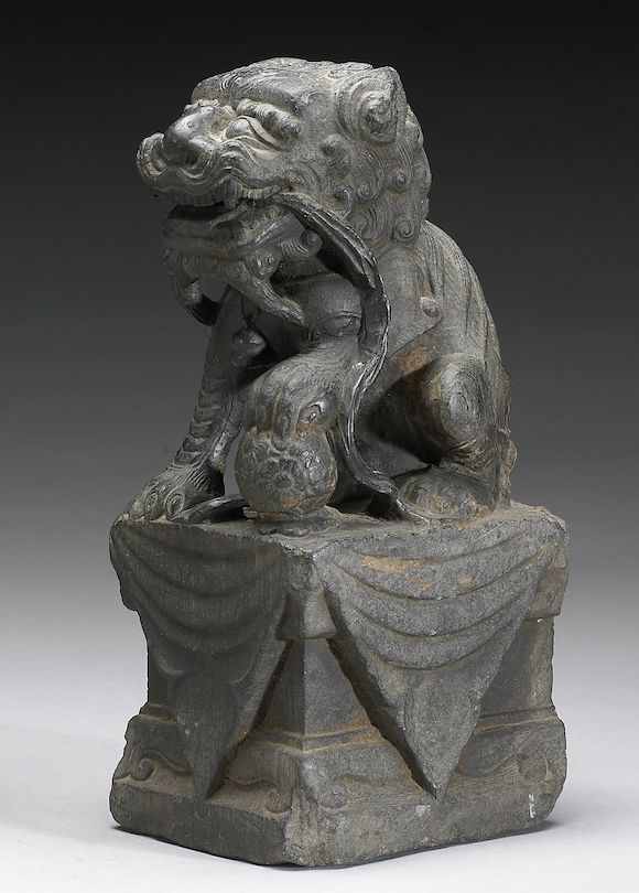 Bonhams : A carved grey stone model of a lion