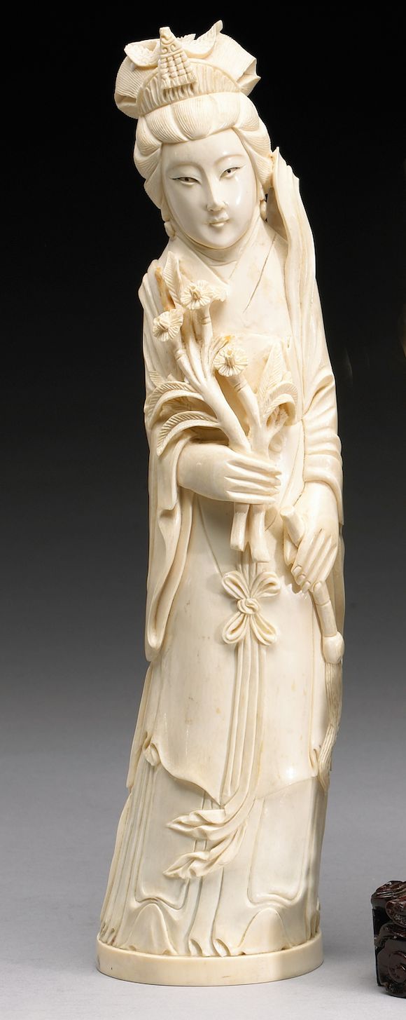 Bonhams : An ivory beauty holding flowers