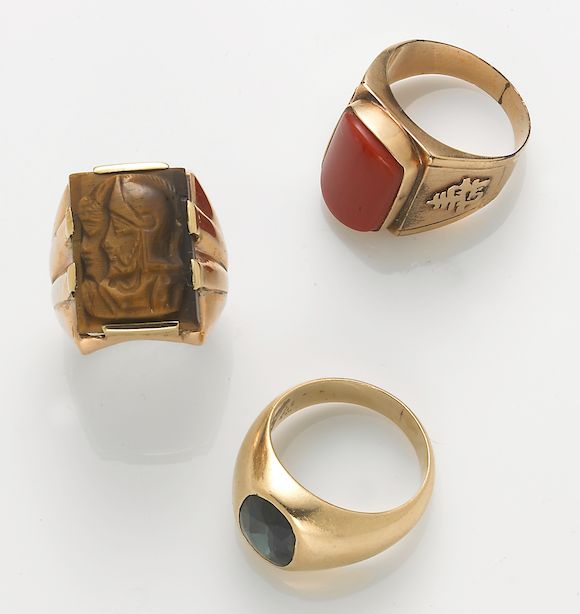 Bonhams : A collection of three sapphire, coral, tiger's eye and 14k ...