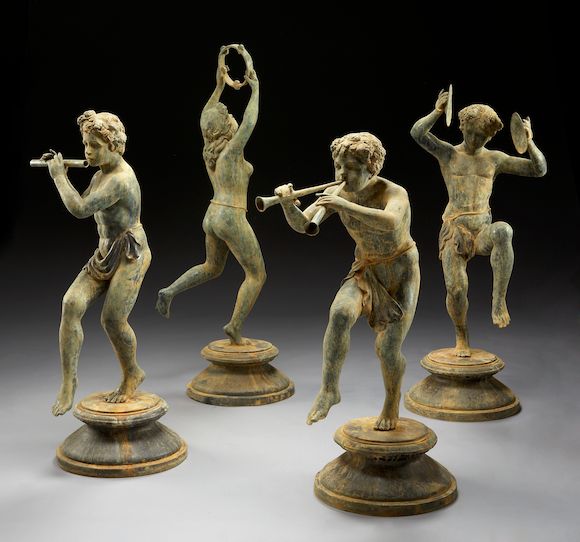 Bonhams : A set of four patinated bronze figures of putti musicians