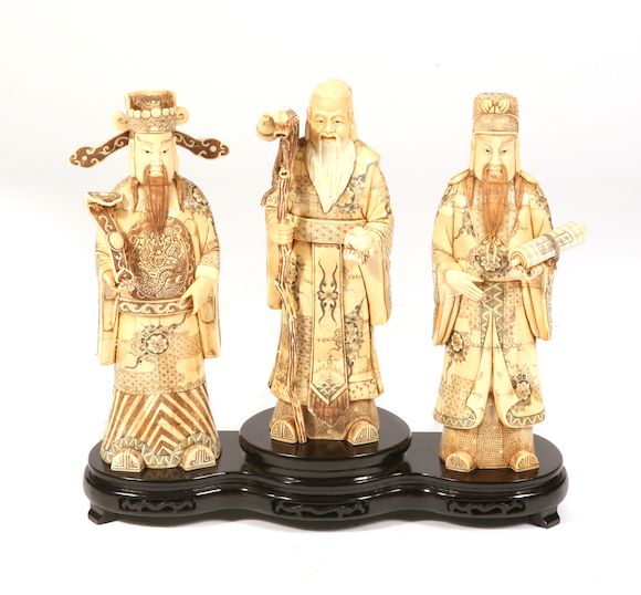 Bonhams : A set of three Chinese carved bone veneer figures on stand