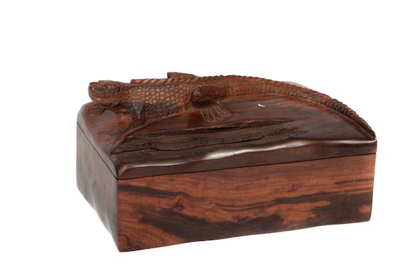 Bonhams : An Ironwood carved box with a figural cover