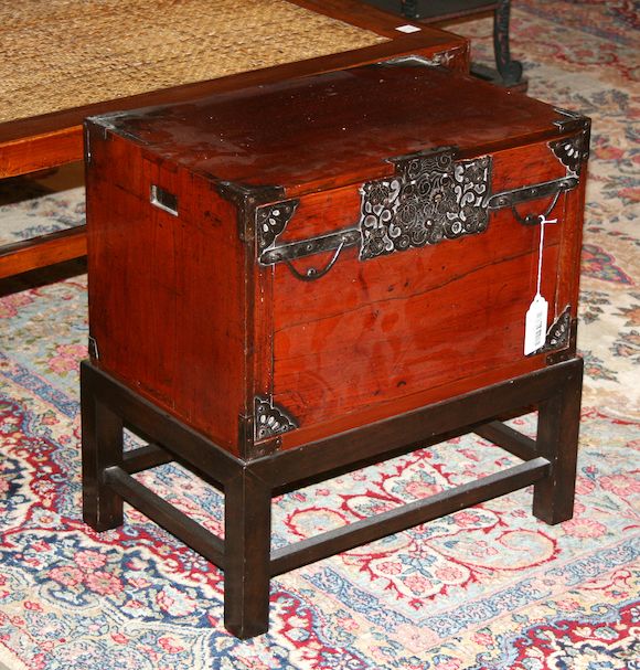 Bonhams : A small Japanese mixed wood merchant's chest on later wood stand