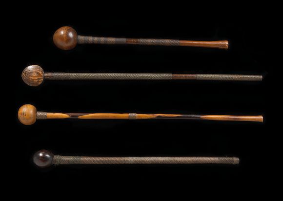 Bonhams : A group of four knobkerry clubs
