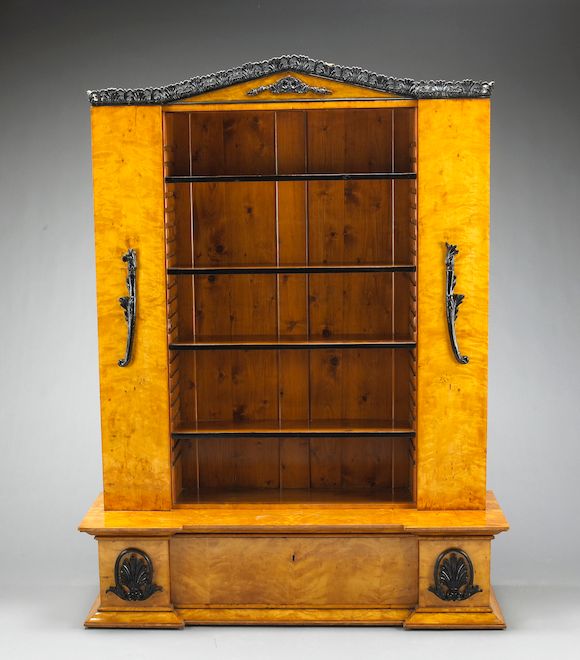 Bonhams : A Biedermeier birch and parcel ebonized bookcase cabinet