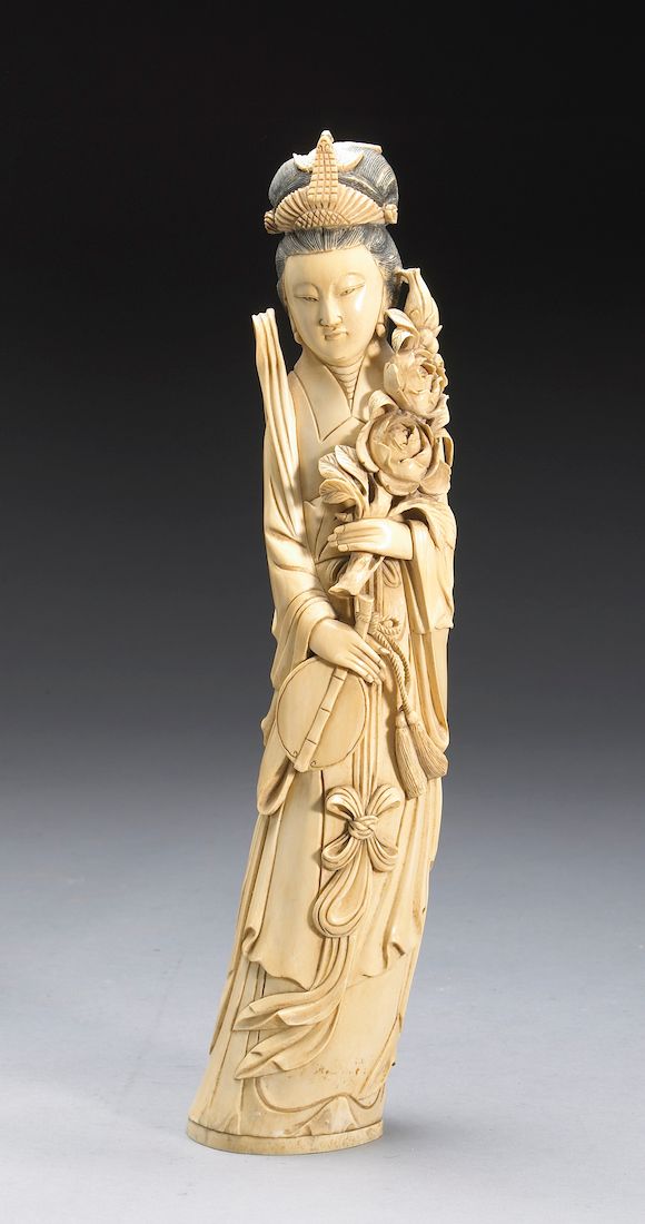 Bonhams : A large tinted ivory figure of a standing beauty 20th Century