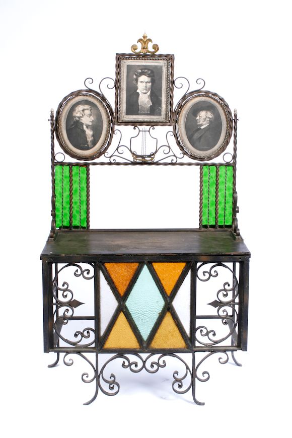 Bonhams : A wrought iron and colored glass music bench