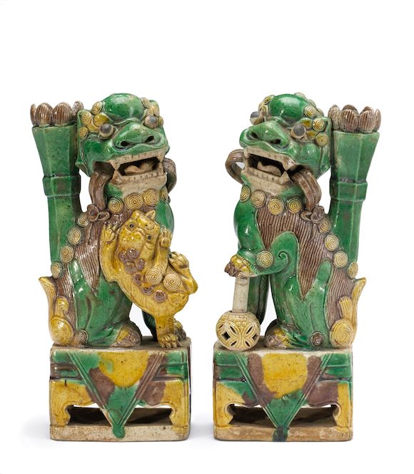 Bonhams : A pair of three-color glazed porcelain fu lions 18th Century