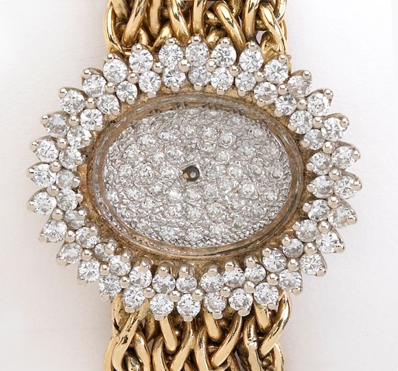 Bonhams : A 14K gold bracelet watch with diamond dial and bezel