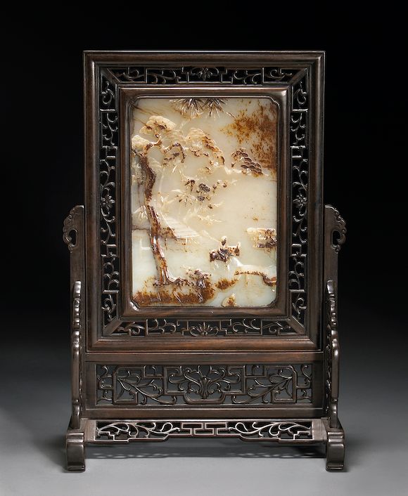 Bonhams : A mottled white jade and reticulated wood table screen