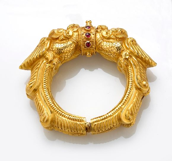 Bonhams : A red stone and heavy gold plated dragon bracelet