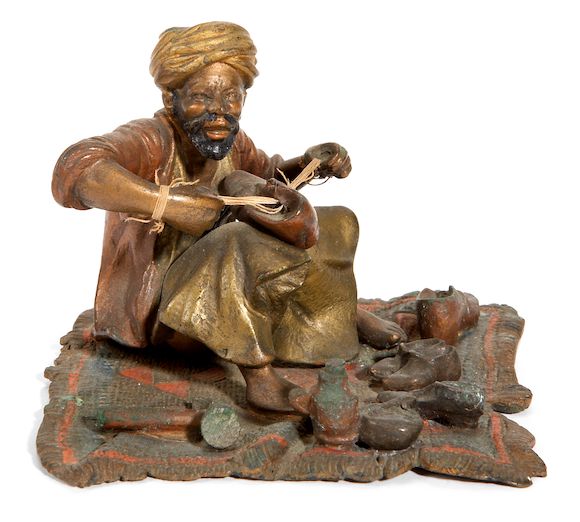 Bonhams : An Austrian cold painted bronze figure of a shoemaker seated ...