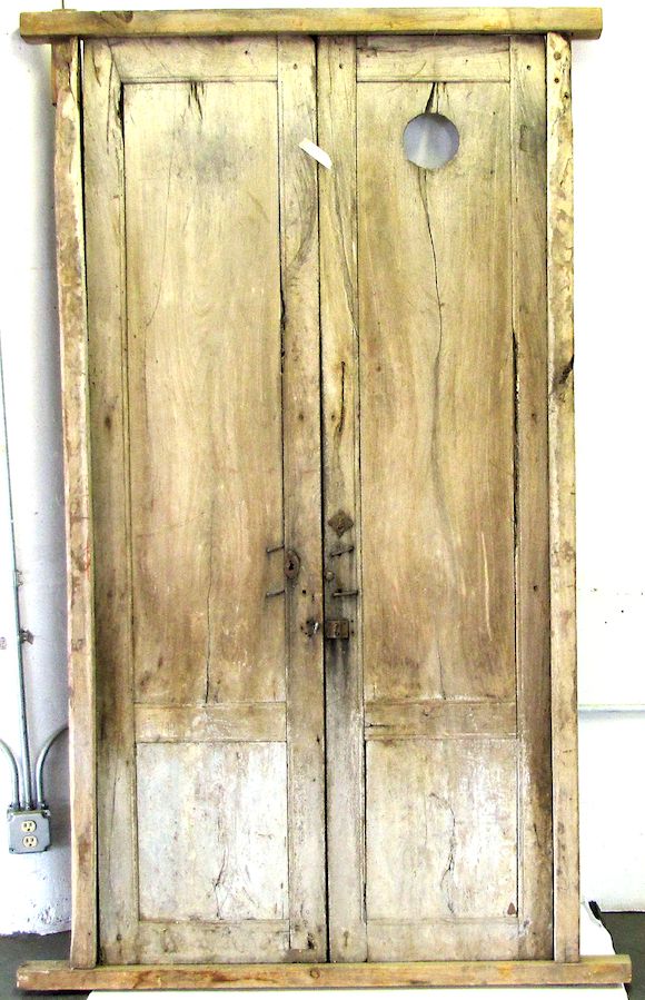 Bonhams : A pair of rusticated wood doors within frames