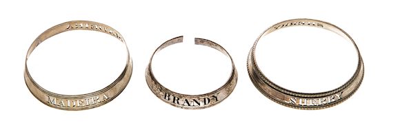 Bonhams : Three English engraved silver wine bottle neck rings