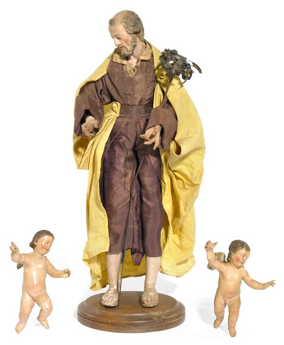 Bonhams : An Italian crèche figure of a man and two putti 19th century