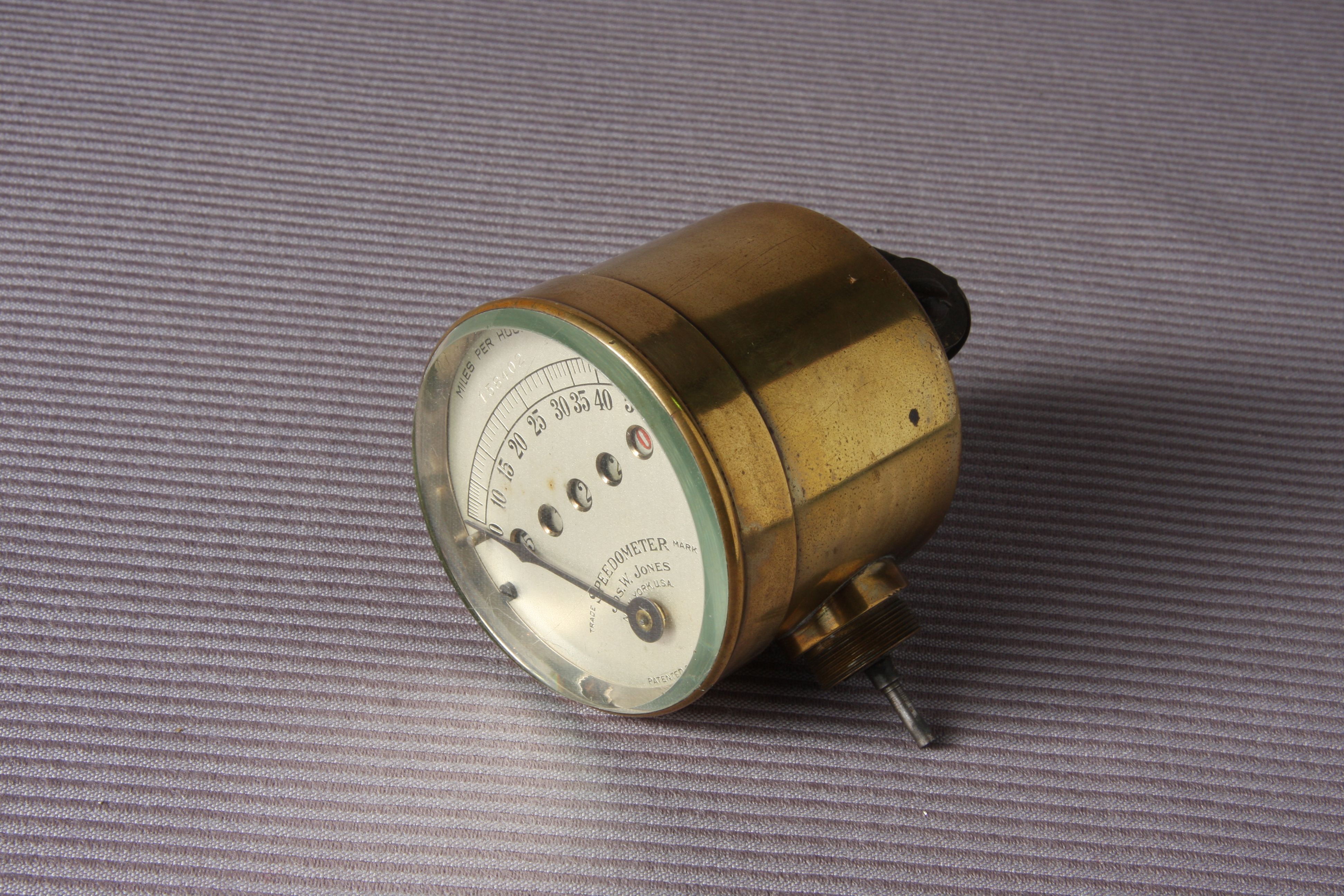 Bonhams Cars : A small Jones 50mph speedometer,