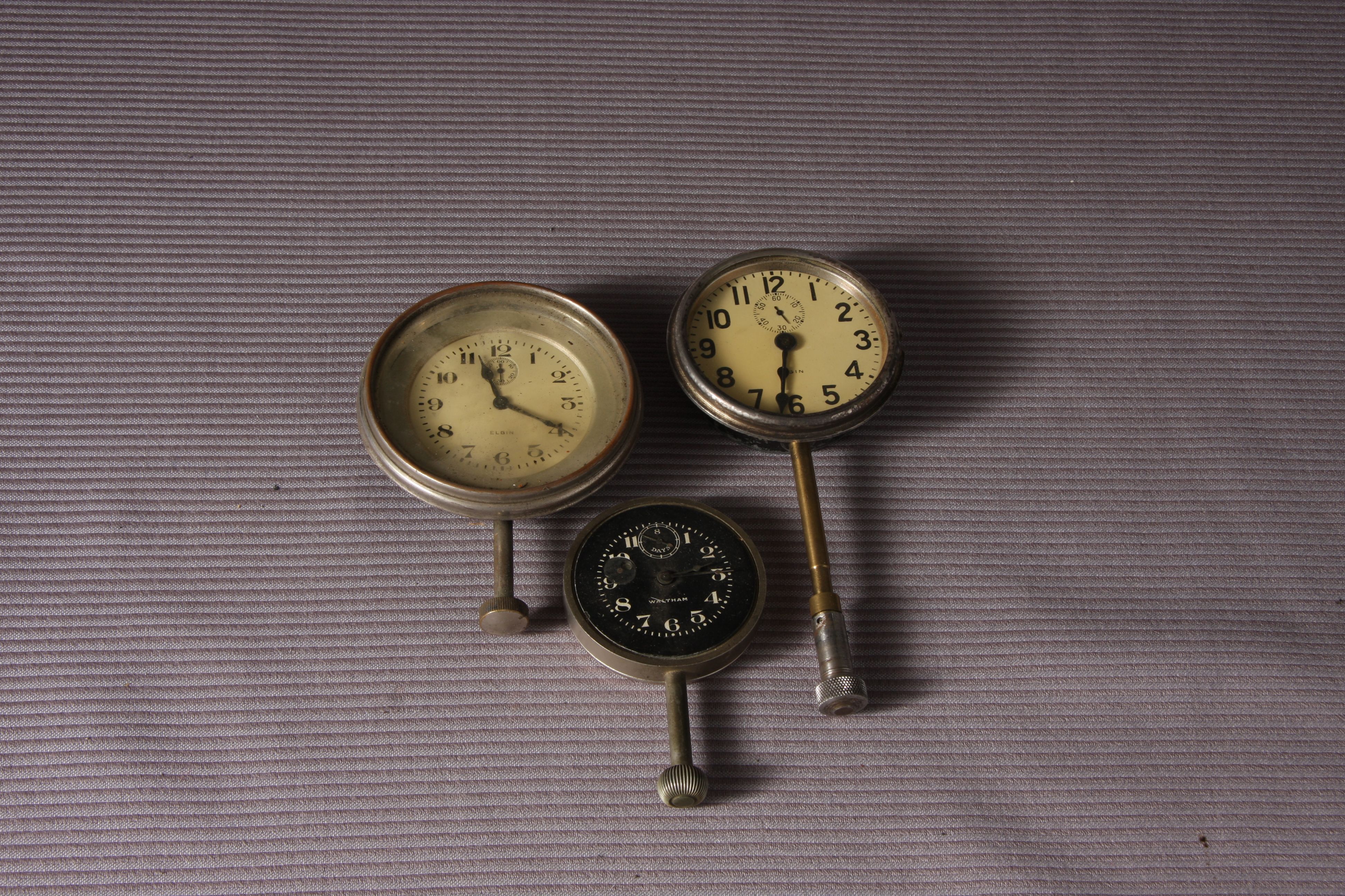Bonhams Cars : Three dashboard mounted clocks,