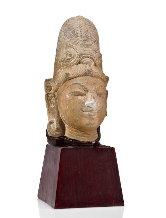Bonhams : A South Indian carved stone head of a deity