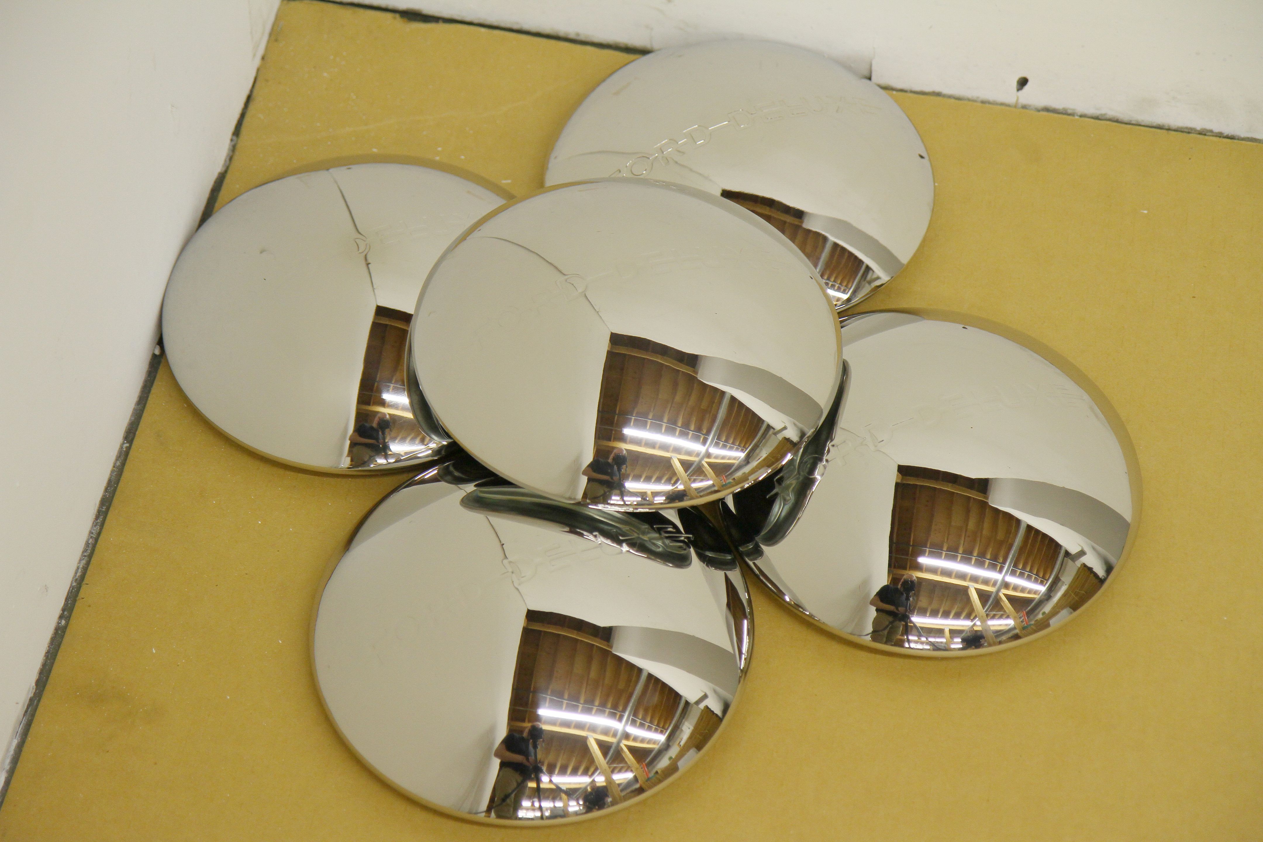 Bonhams Cars : A set of five reproduction 1940s Ford Deluxe hubcaps,