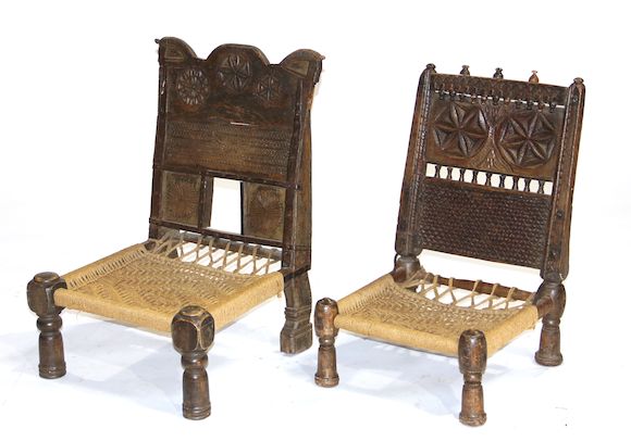 Bonhams : Two similar hardwood and rush seat African low chairs