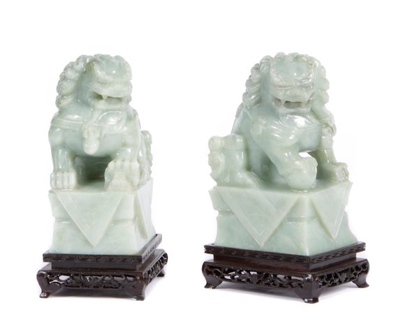 Bonhams : A pair of light green jade temple guardian dogs