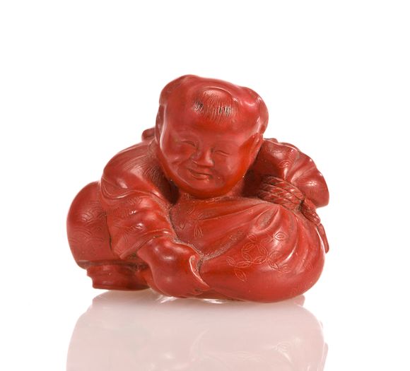 Bonhams : A red lacquer netsuke of a Chinese boy By Ryukei, 19th century