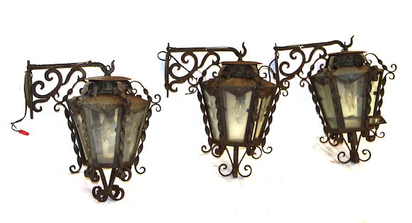 Bonhams : A set of three Renaissance style iron and glass wall lanterns
